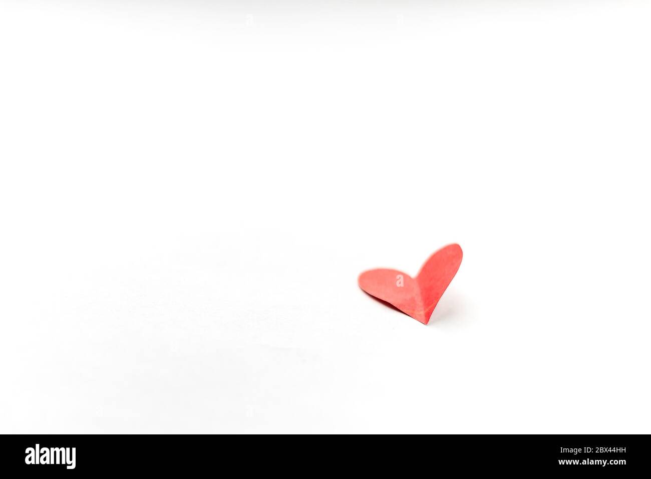Red heart paper on white background minimalism Stock Photo - Alamy