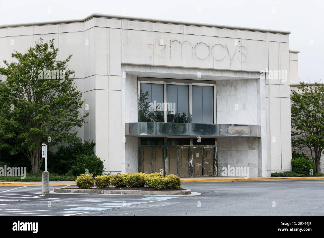 The faded outline of a logo sign outside of a closed and abandoned ...