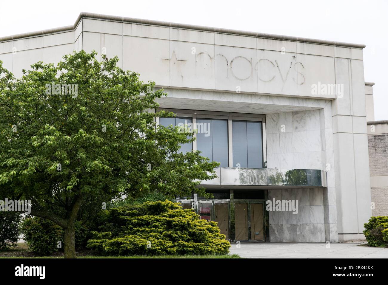 The faded outline of a logo sign outside of a closed and abandoned ...