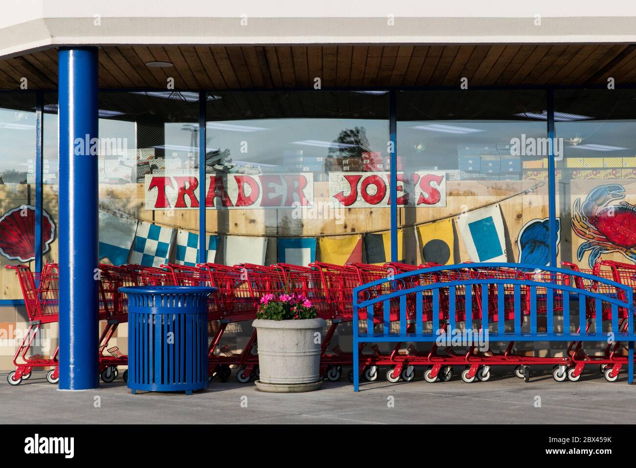 A logo sign outside of a Trader Joes retail grocery store location in ...