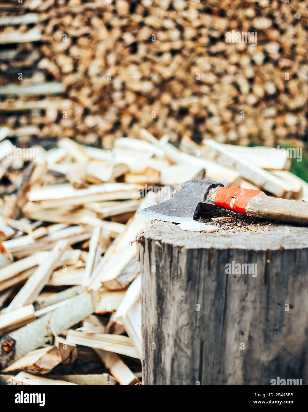 Chopped wood piled in a woodpile and prepared for heating in winter ...