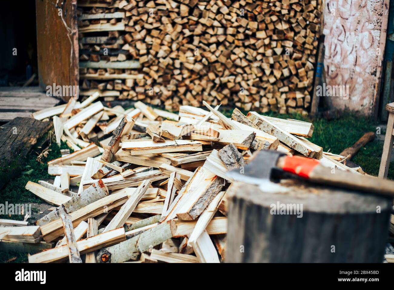 Chopped wood piled in a woodpile and prepared for heating in winter ...