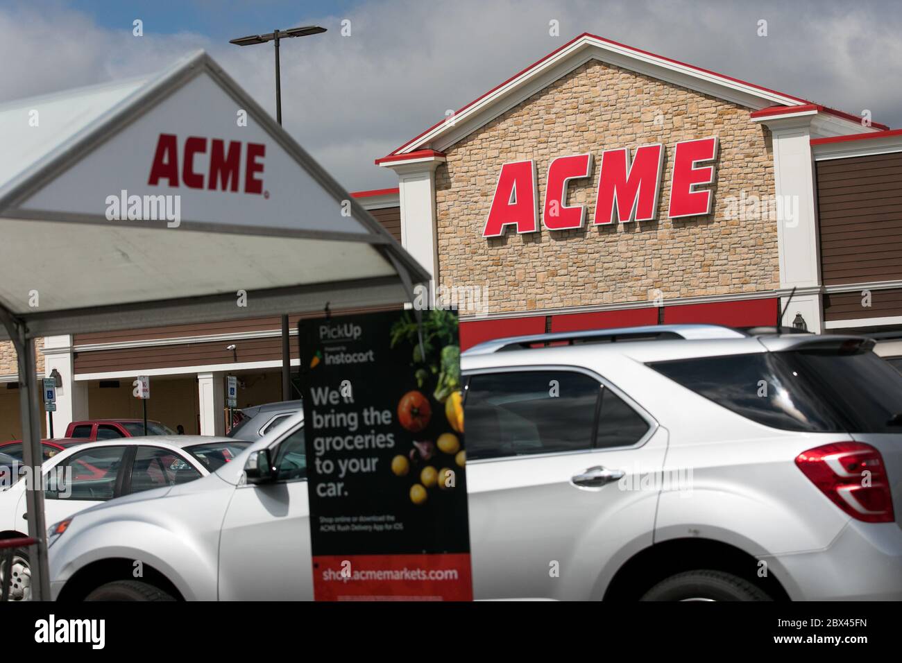 A logo sign outside of Acme retail grocery store location in ...
