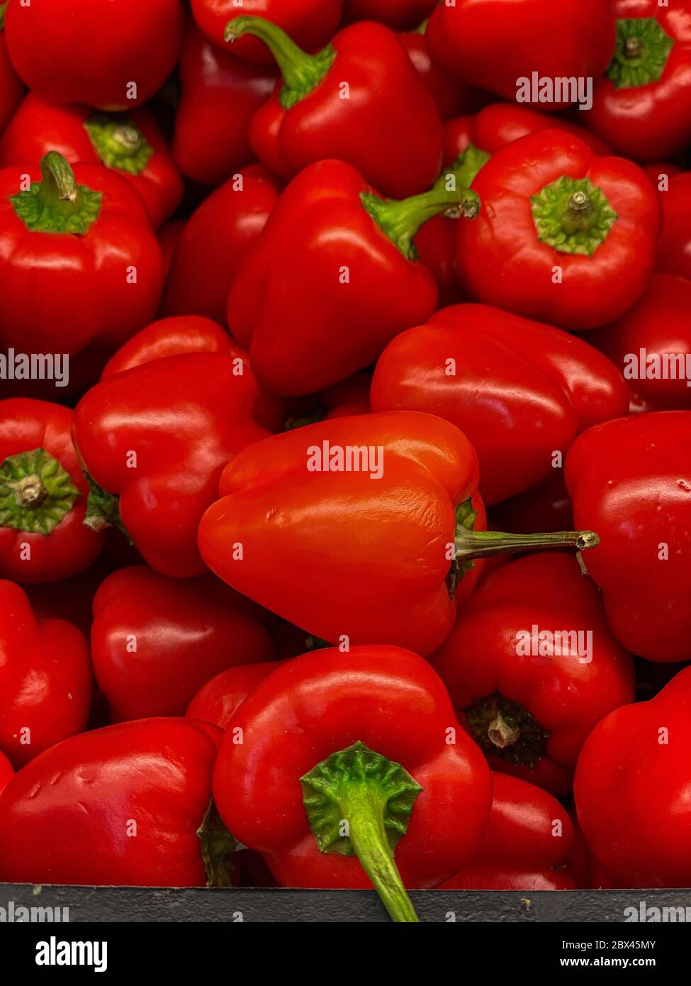 Displaying imported red peppers Stock Photo - Alamy