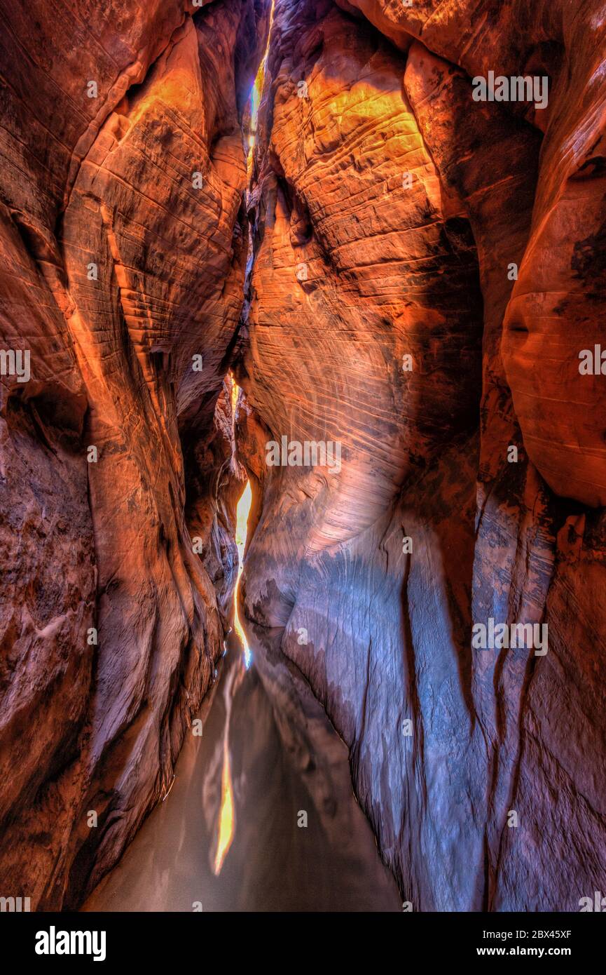 A long exposure of soft, warm light reflected in the pool in colorful ...