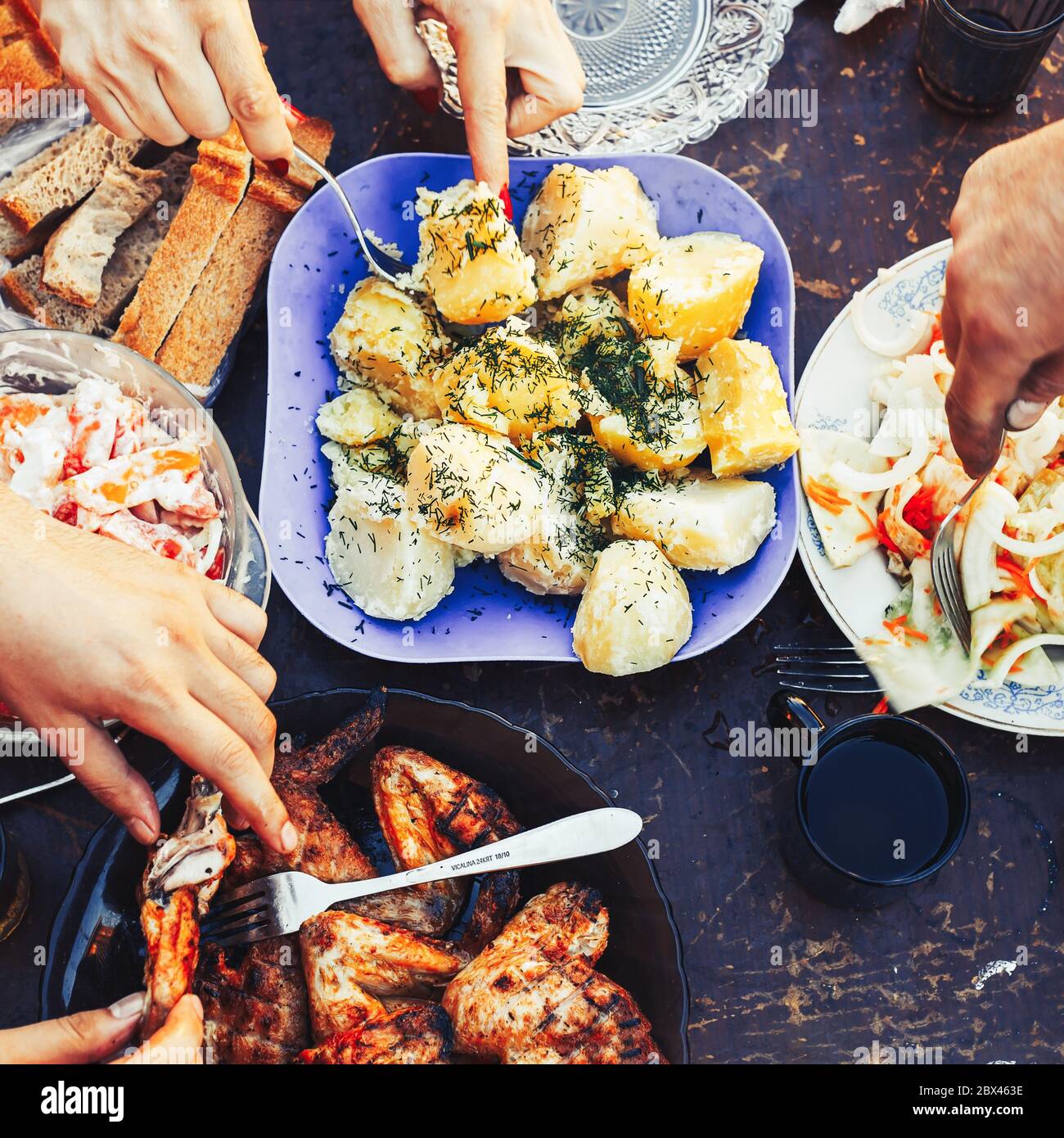 Food Concept Friends at a dinner table with different food Stock Photo ...