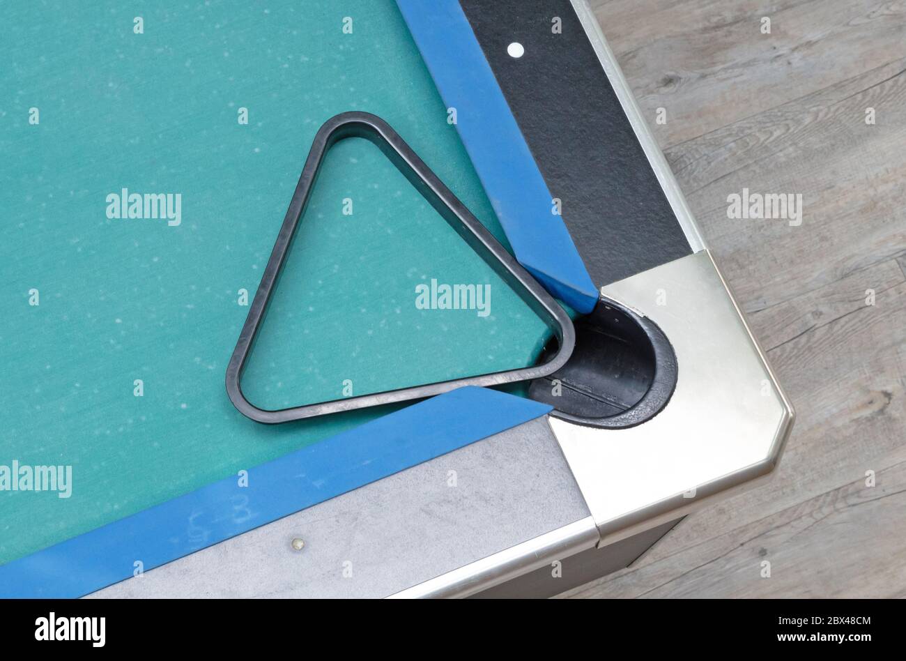 Well used part of green with blue edges and black ball hole pool table ...