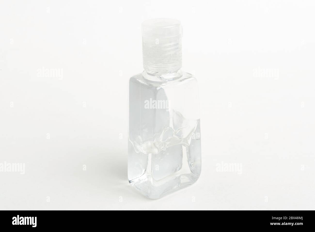 A product shot of a generic pocket-size transparent hand sanitizer ...
