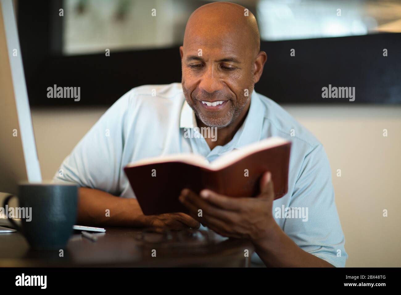 African American man praying and reading the Bible Stock Photo - Alamy