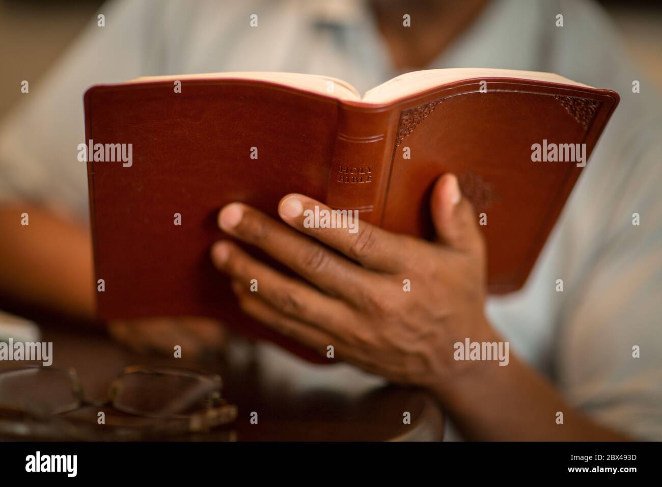 African American man praying and reading the Bible Stock Photo - Alamy