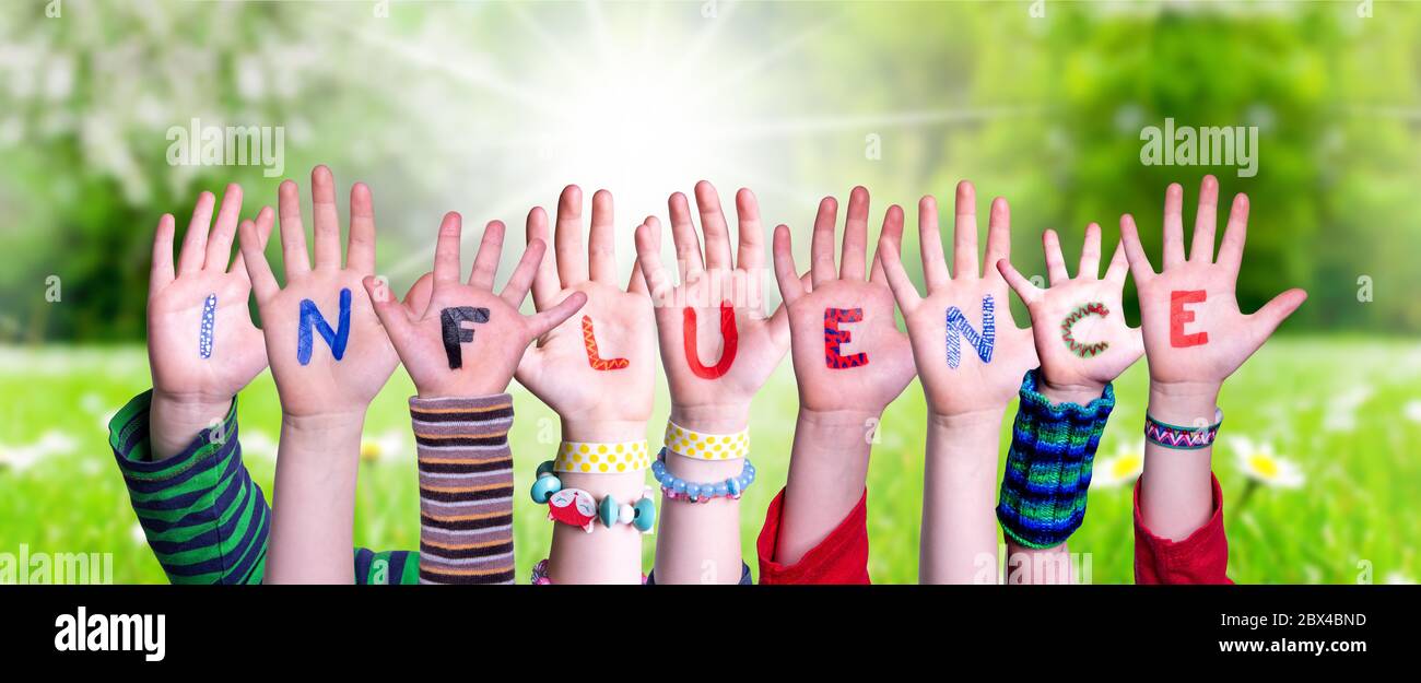 Children Hands Building Word Influence, Grass Meadow Stock Photo - Alamy