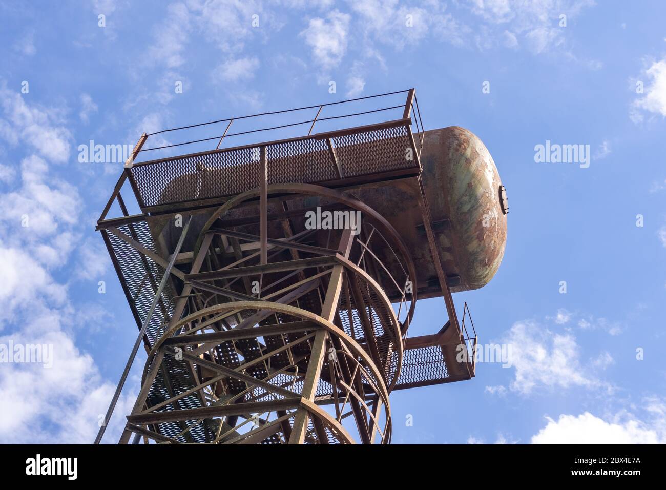 Upward view of rusty metal tower, tank for water Stock Photo - Alamy