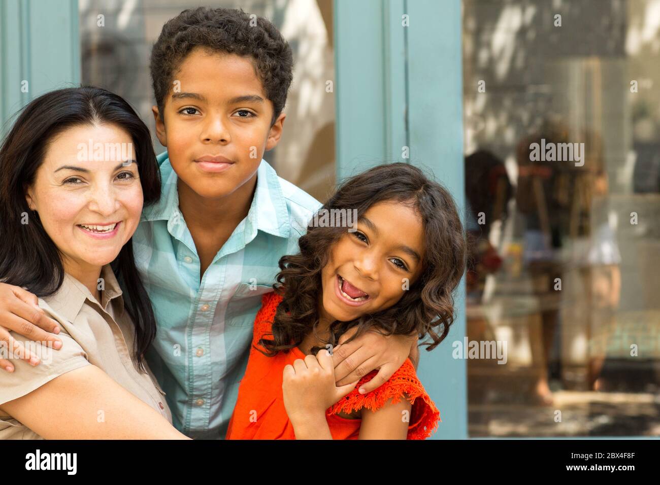 Happy Hispanic mother laughing and talking with her children Stock ...