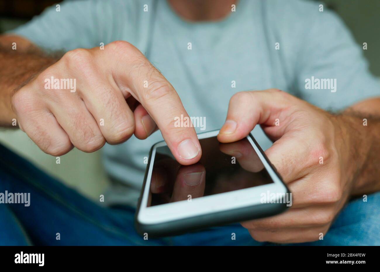 faceless lifestyle portrait with close up hands of young man holding ...