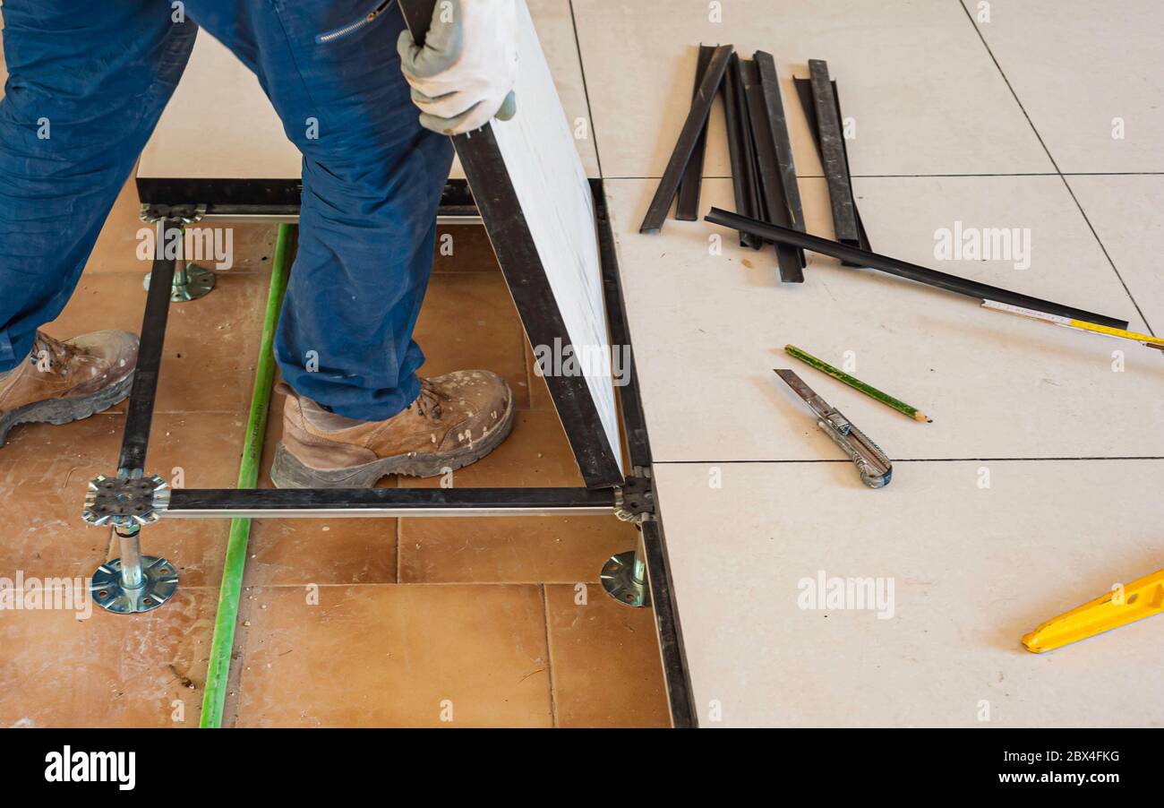 Worker working Raised floor in modern interior of server room in ...