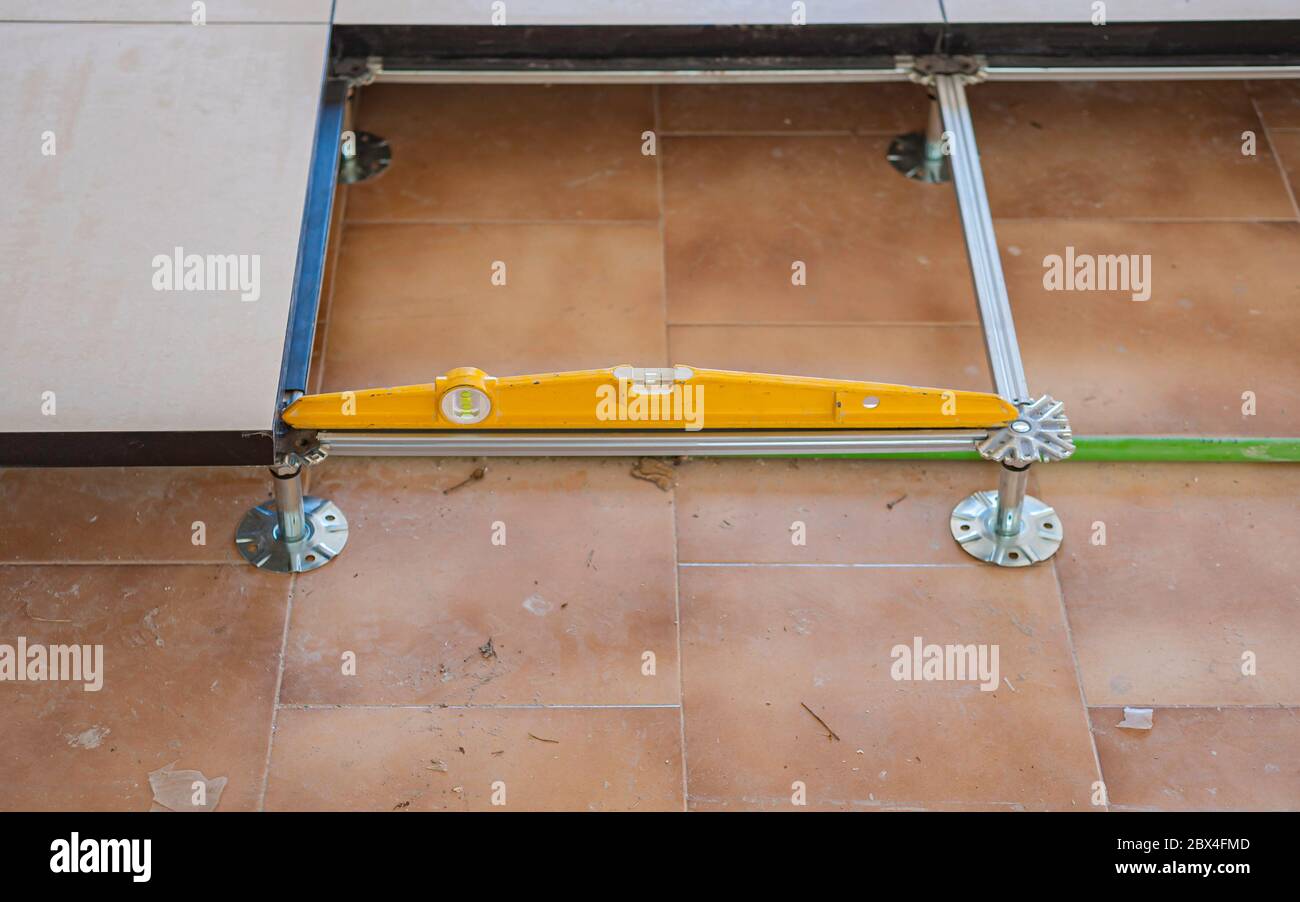 Worker working Raised floor in modern interior of server room in ...