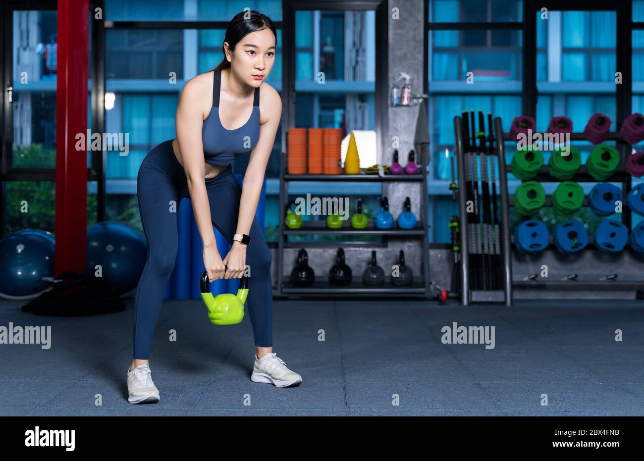 Healthy asian women are doing lifting gear, she's doing weight training ...