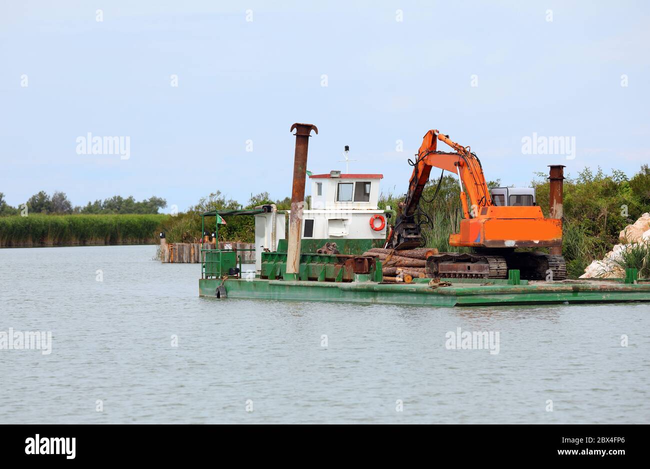 Construction site on the river with excavator on the barge boat Stock ...