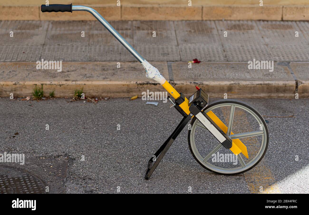 Surveyor with measuring wheel (odometer) detects the length of an ...