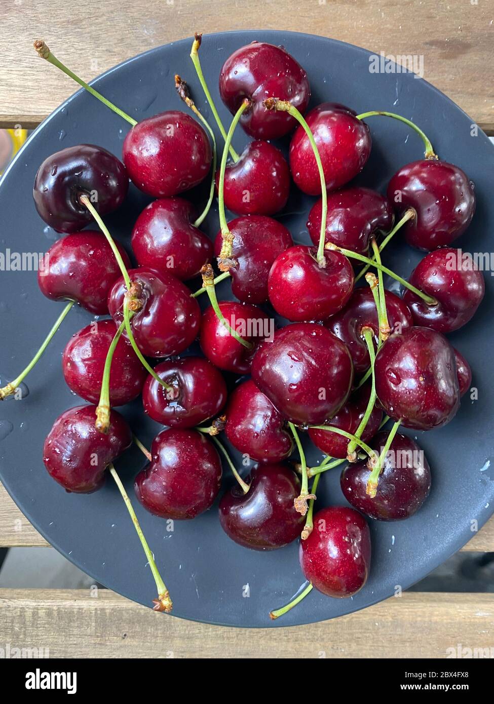 Top view cherry in plate, closeup Stock Photo - Alamy