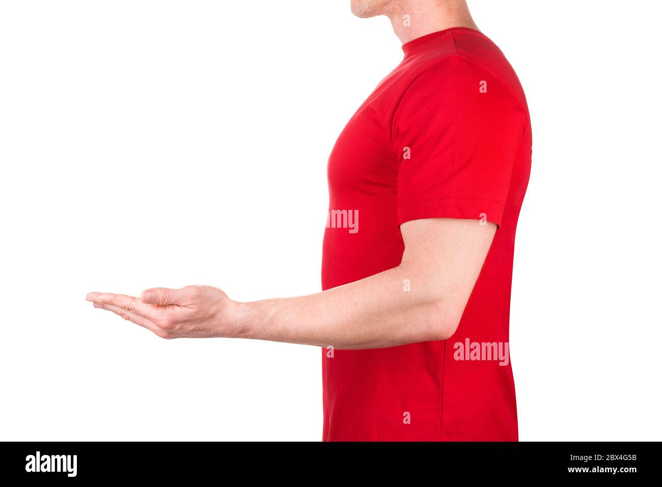 Front view of confident male in blank red t-shirt hold something ...