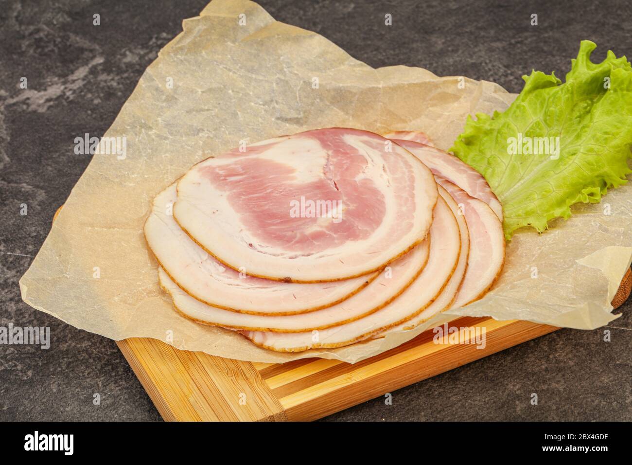 Sliced Italian Pancetta sausage over board Stock Photo - Alamy