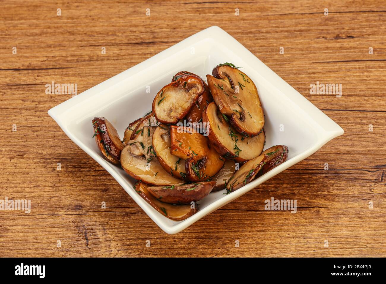 Roasted champignon with herbs and spices in the bowl Stock Photo - Alamy