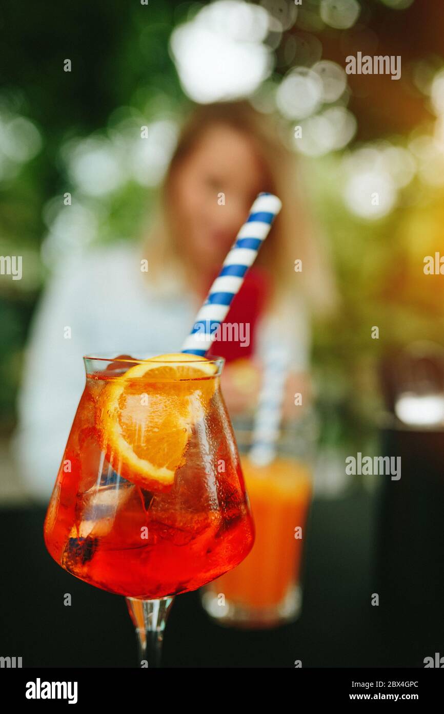 Glass of Aperol Spritz and blue straw, Italian Cocktail. Fine film ...