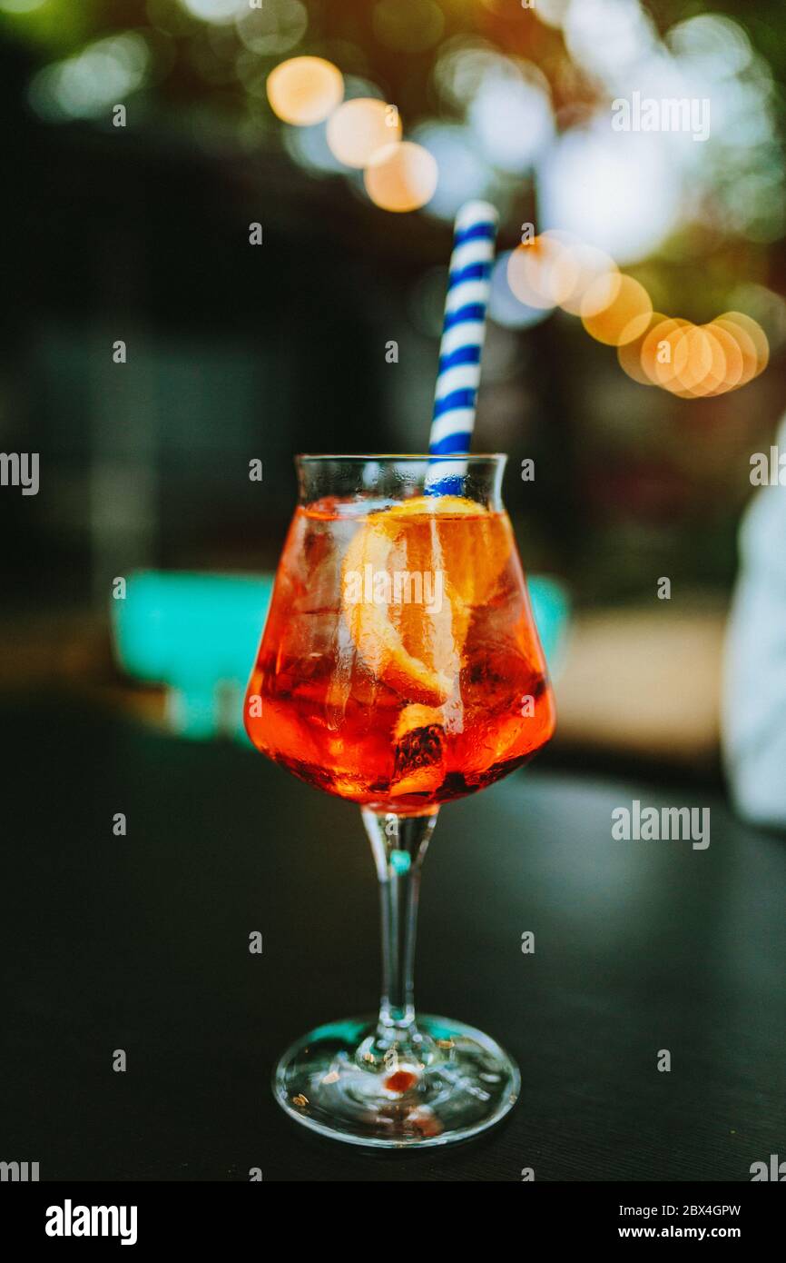 Glass of Aperol Spritz and blue straw, Italian Cocktail. Fine film ...
