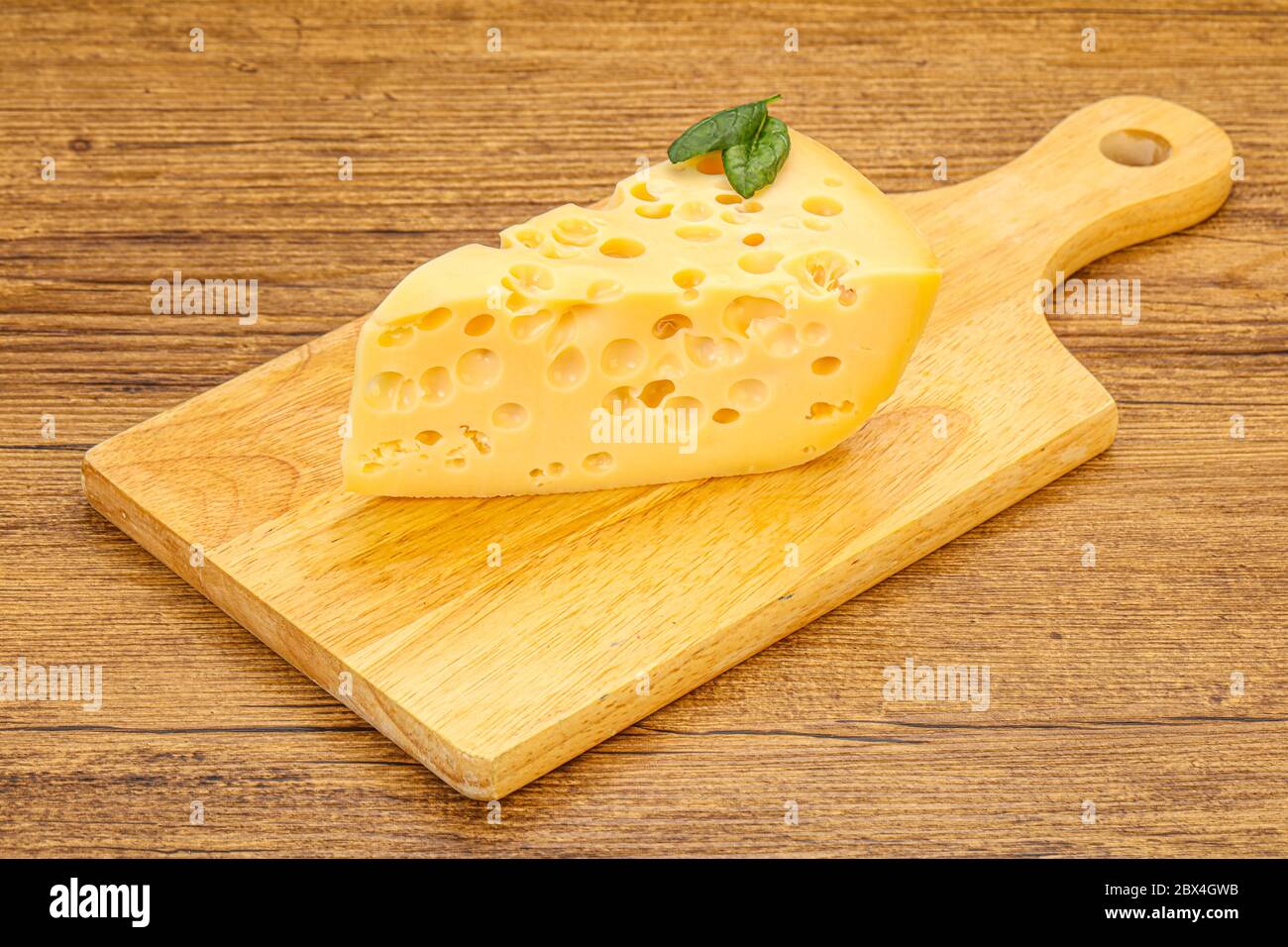 Maasdam cheese - dairy yellow triangle with holes Stock Photo - Alamy