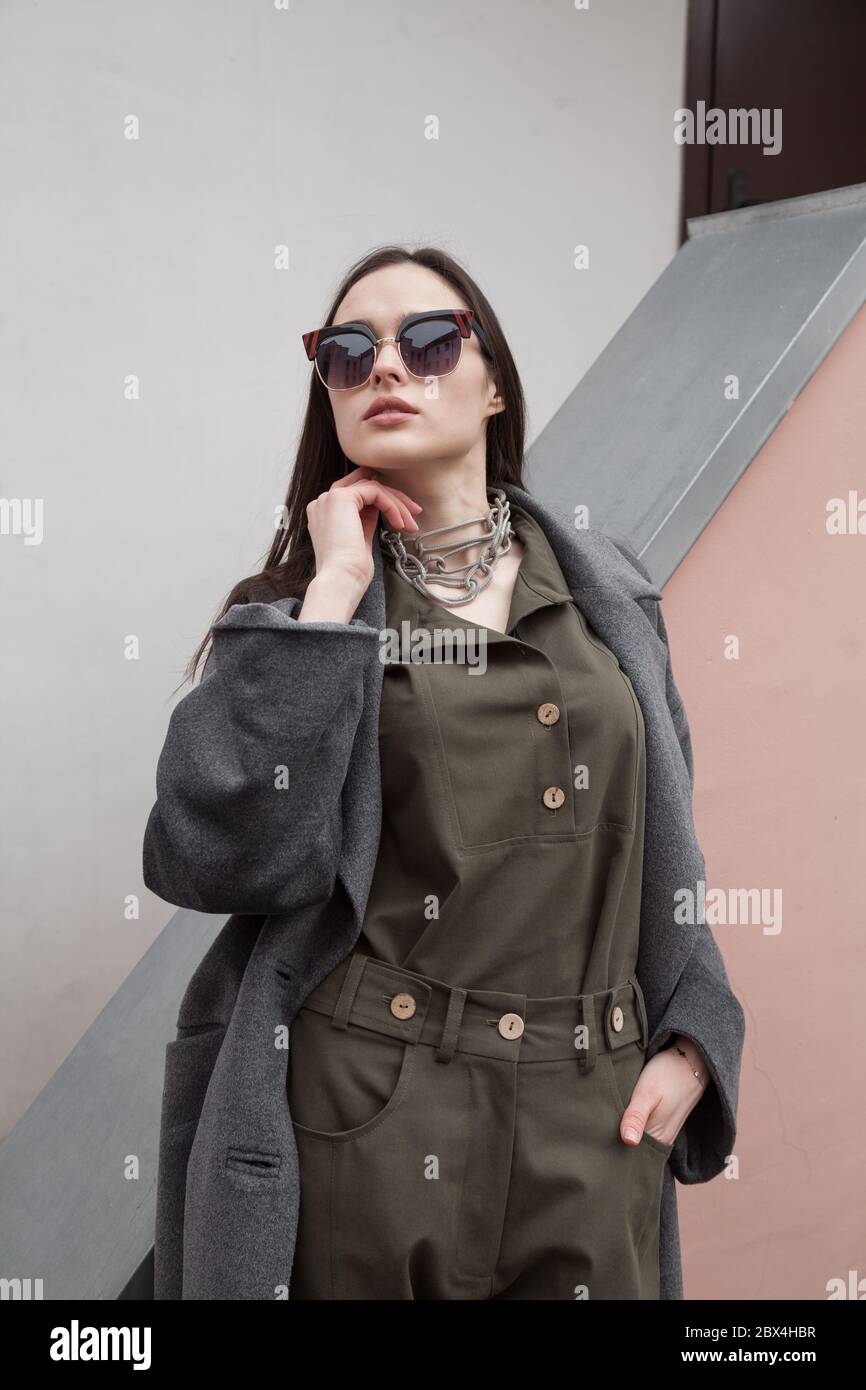 Female trendy model woman look at distance outdoors. Full length ...