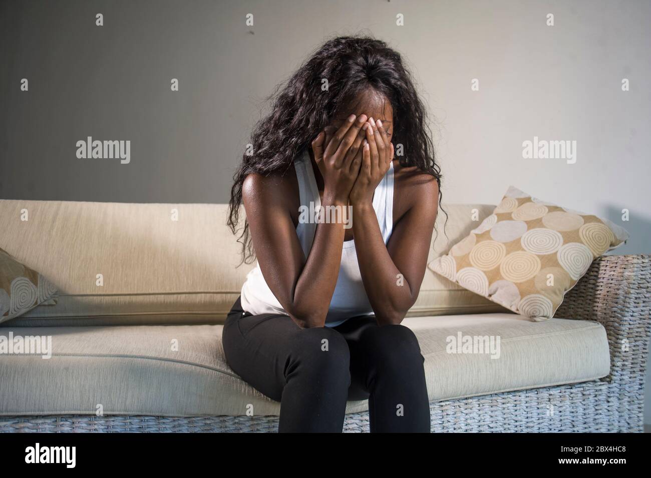 young attractive and sad black African American woman sitting depressed ...