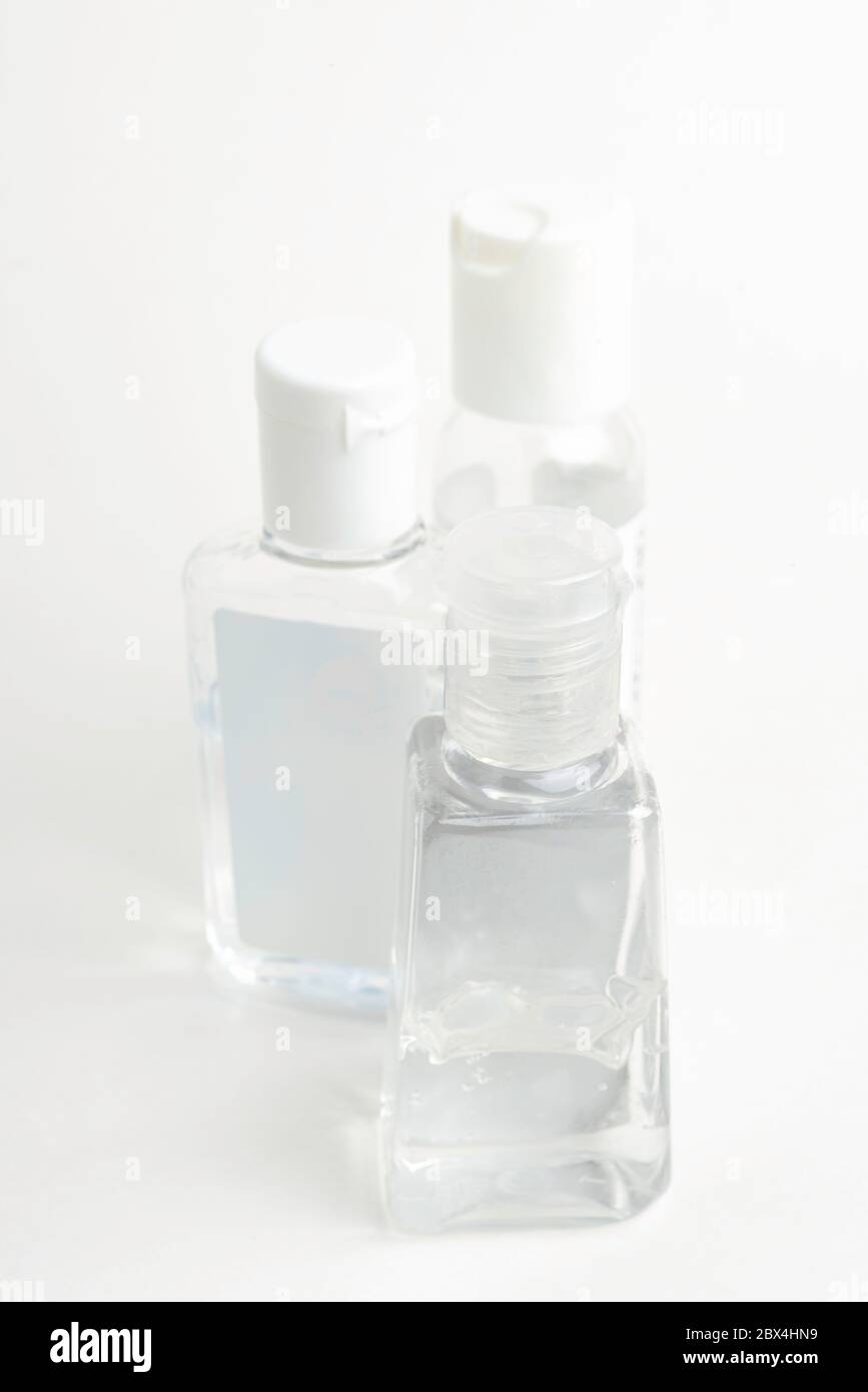 A product shot of three generic pocket-size transparent hand sanitizer ...