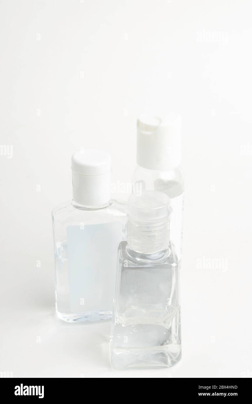 A product shot of three generic pocket-size transparent hand sanitizer ...