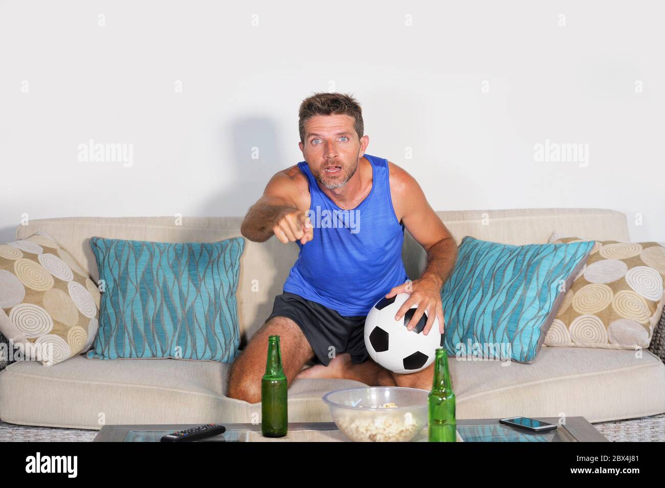 passionate football fan supporter man watching match on television ...