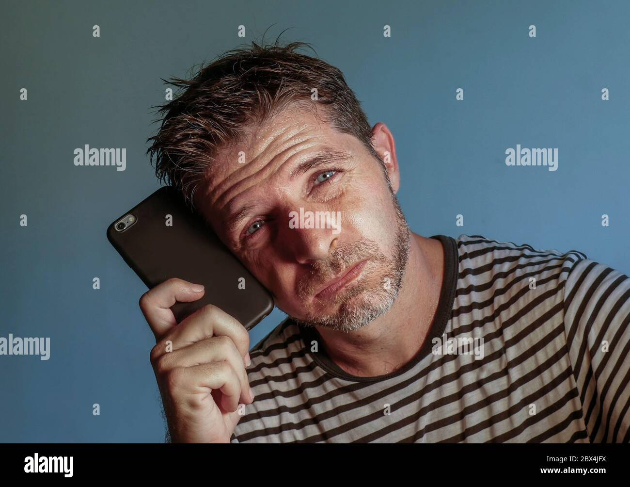 close up face portrait of young attractive and stressed man using ...