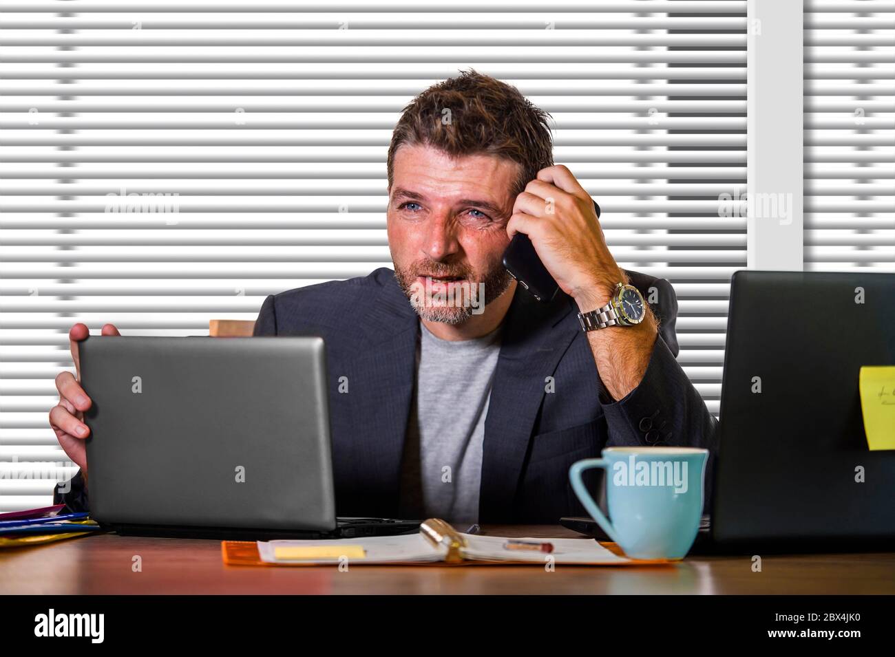 young attractive upset and stressed businessman working overwhelmed ...