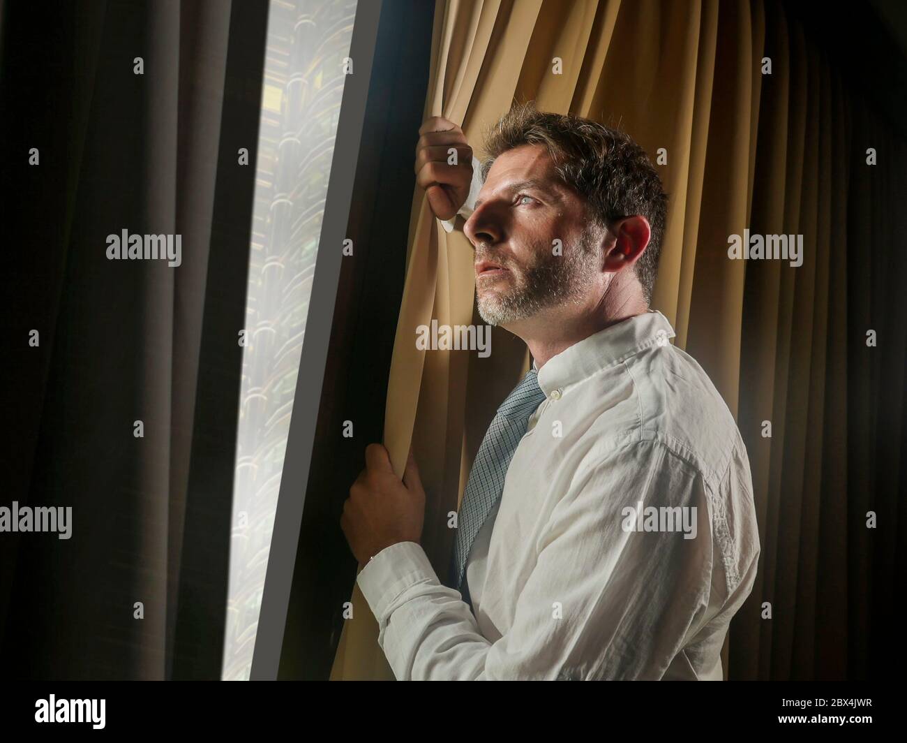 dramatic night light office portrait of businessman working late ...