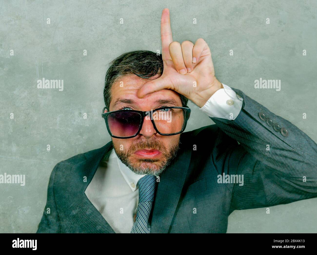 30s or 40s messy businessman in suit and tie sad and ashamed in weird ...