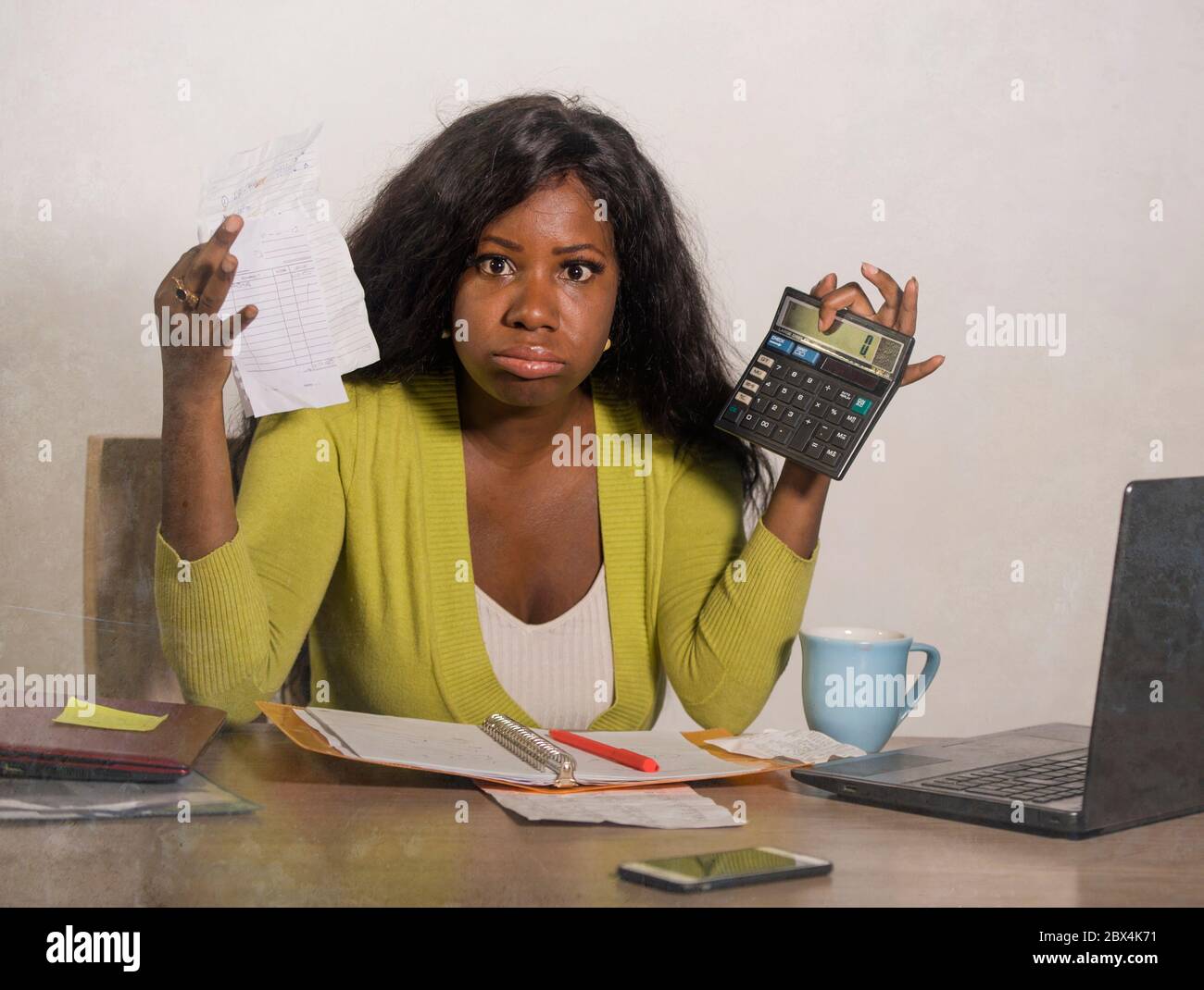 young stressed and overwhelmed black African American woman doing ...