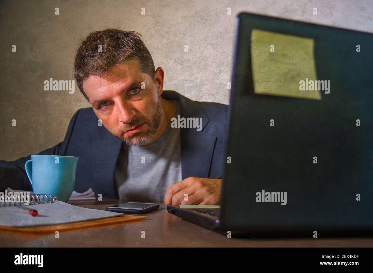 young attractive depressed and frustrated man working at office ...