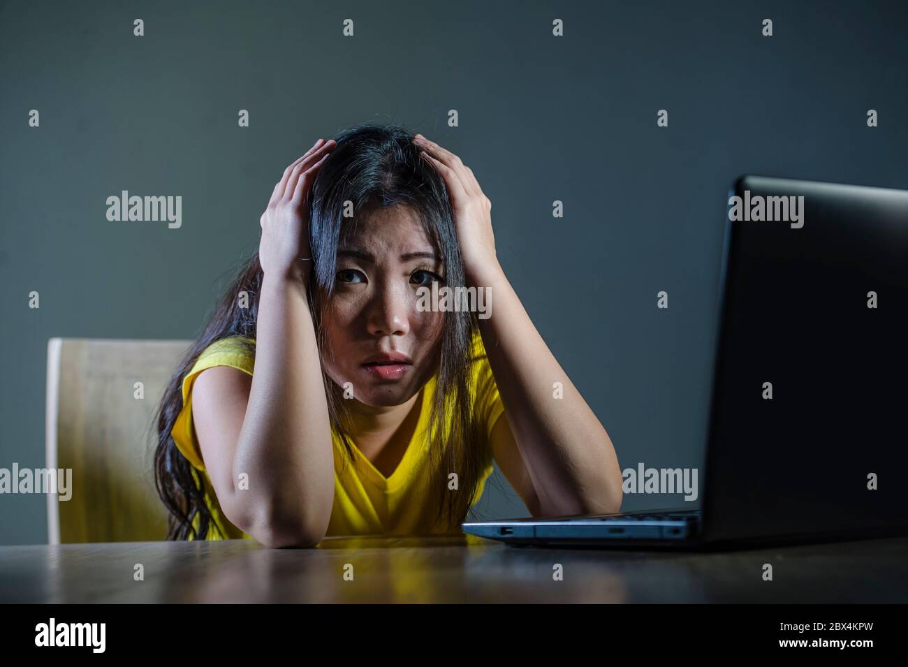 dramatic portrait of scared and stressed Asian Korean teenager girl or ...
