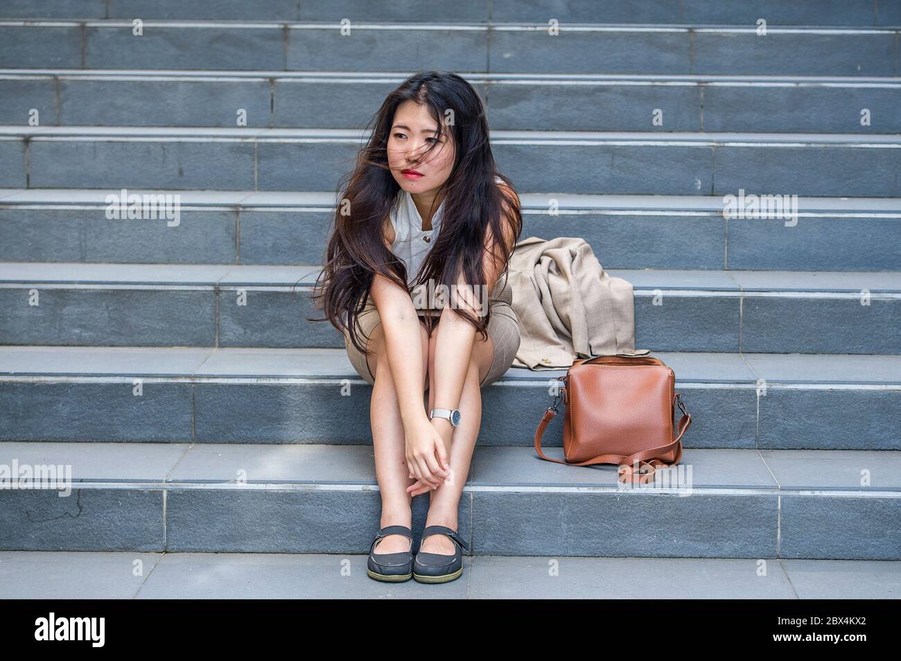 young depressed and desperate Asian Chinese businesswoman crying alone ...