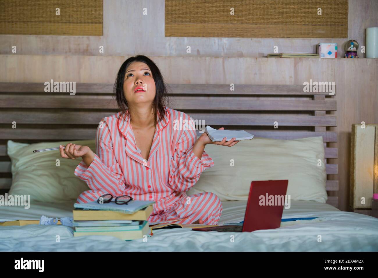 young frustrated and tired Asian Japanese university student girl ...