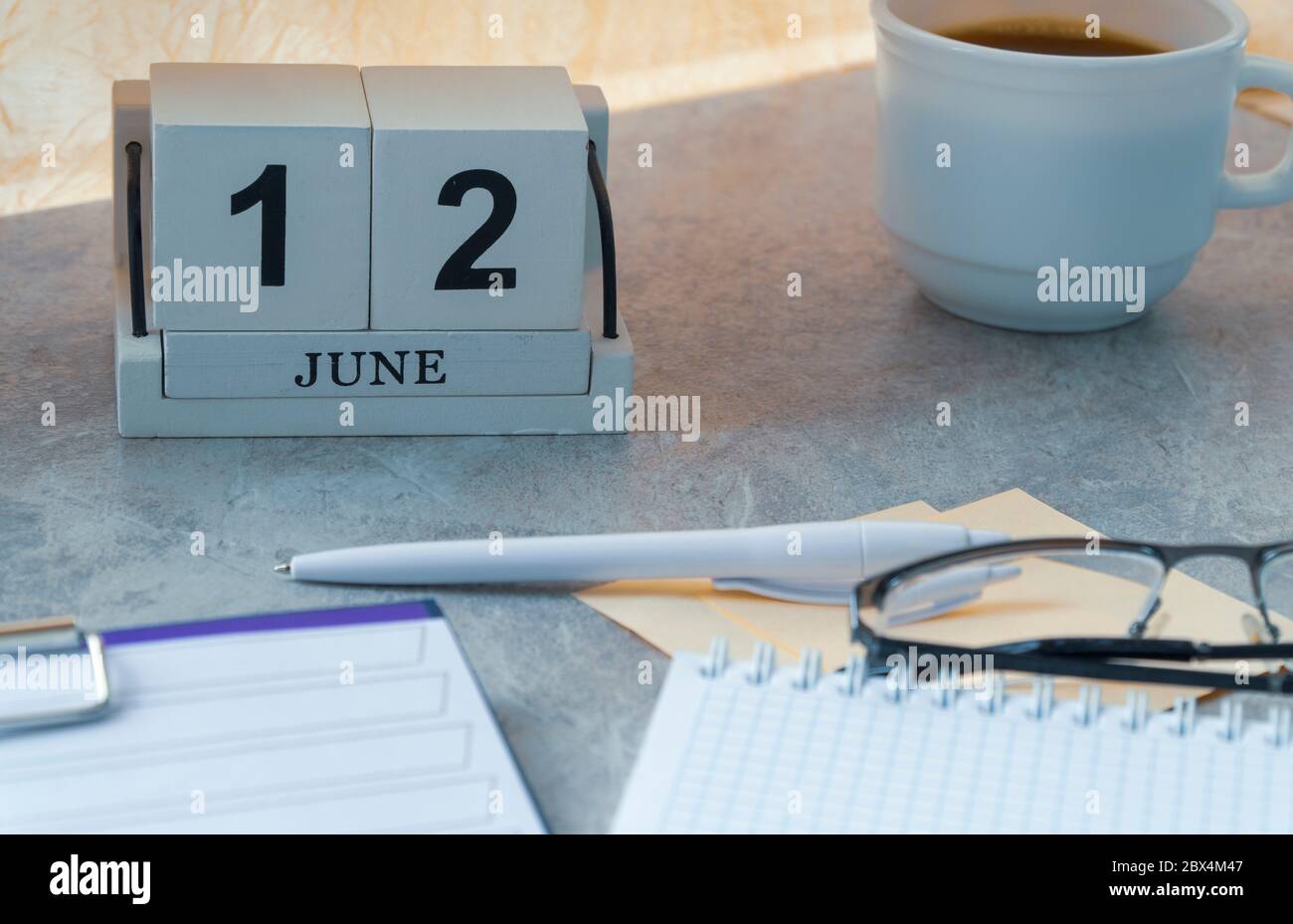June 12, date on the calendar. Handmade wood cube with date month and ...
