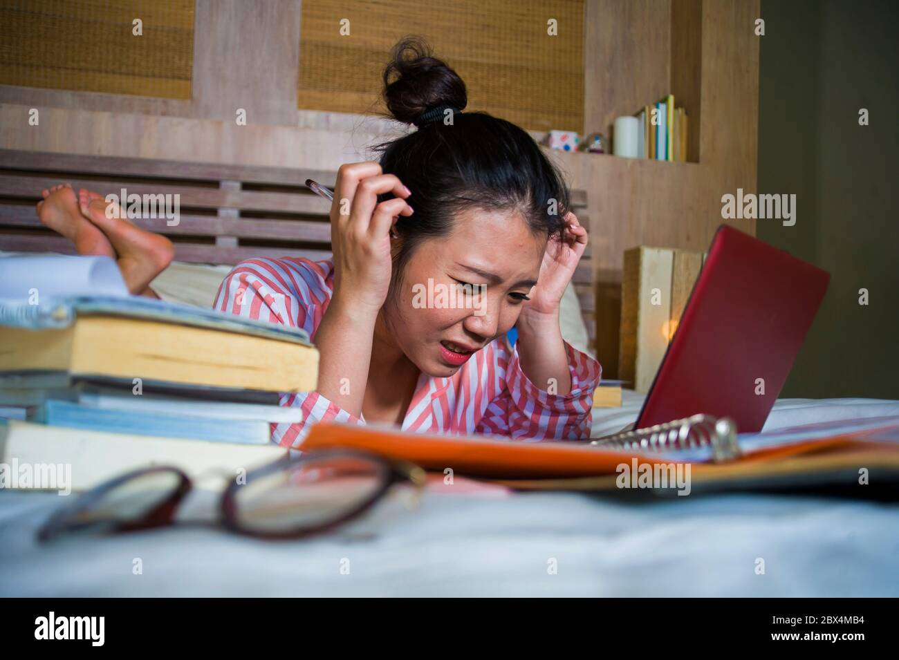 young desperate and tired Asian Korean university student woman feeling ...