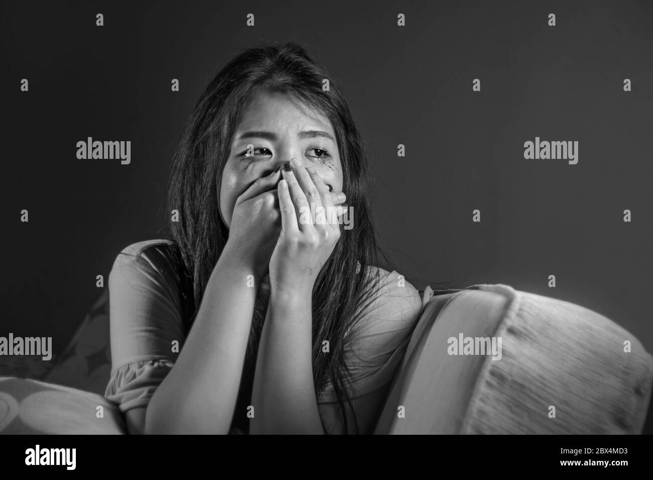 lifestyle black and white portrait of young sad and depressed Asian ...