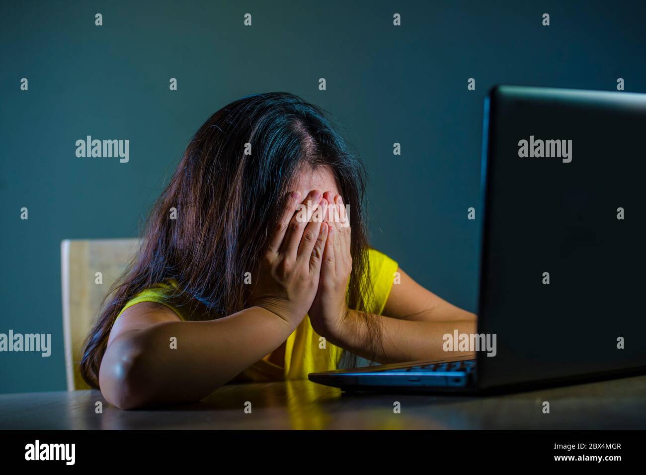 dramatic portrait of young sad and scared woman covering face with ...