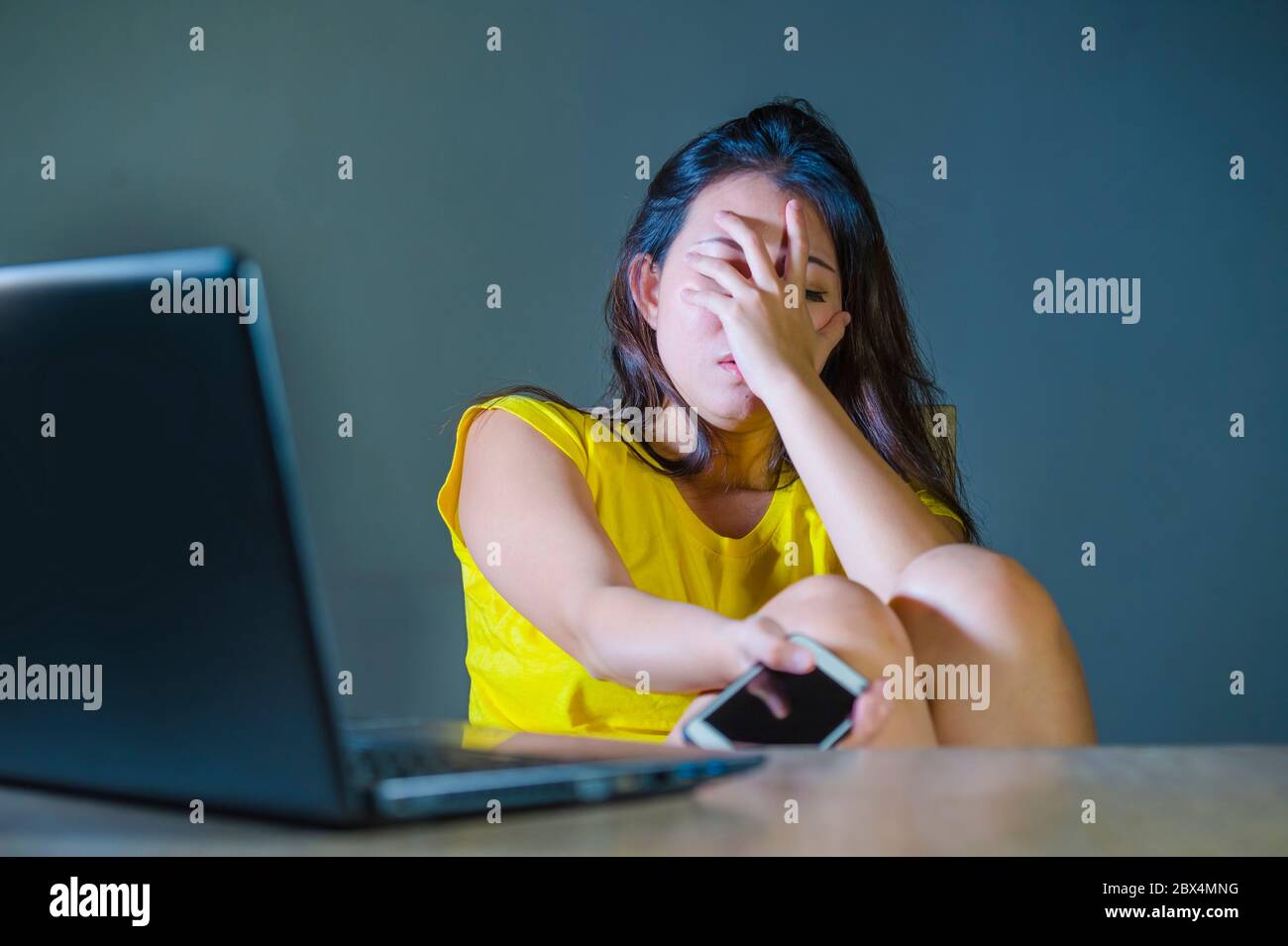dramatic portrait of young sad and scared woman covering face with ...
