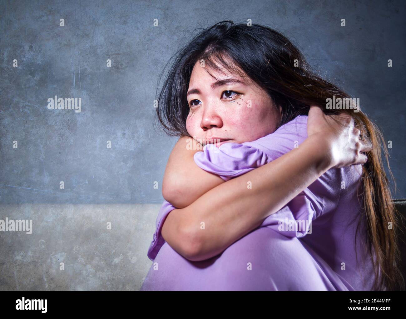 young sad and depressed Asian Chinese woman crying alone desperate ...